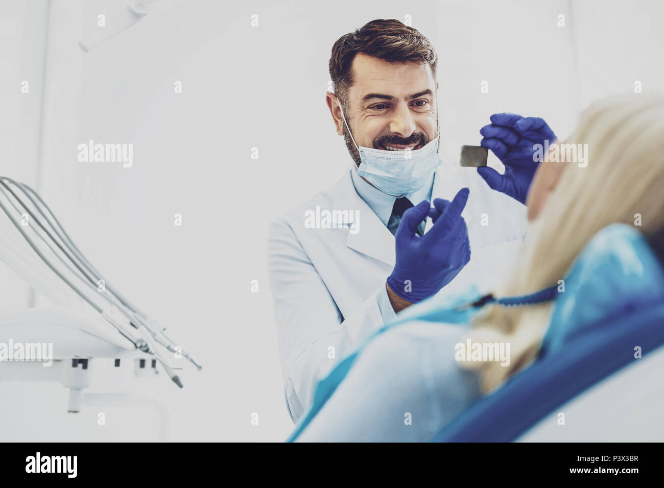 Pleased stomatologist pointing at X-ray picture Stock Photo - Alamy