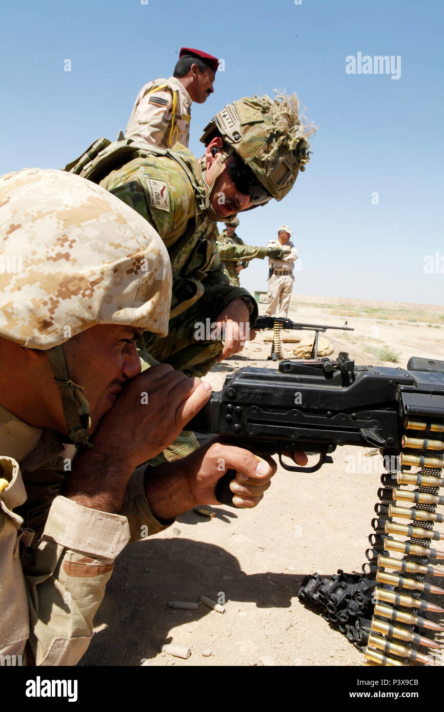An Australian coalition trainer observes an Iraqi soldier firing a ...