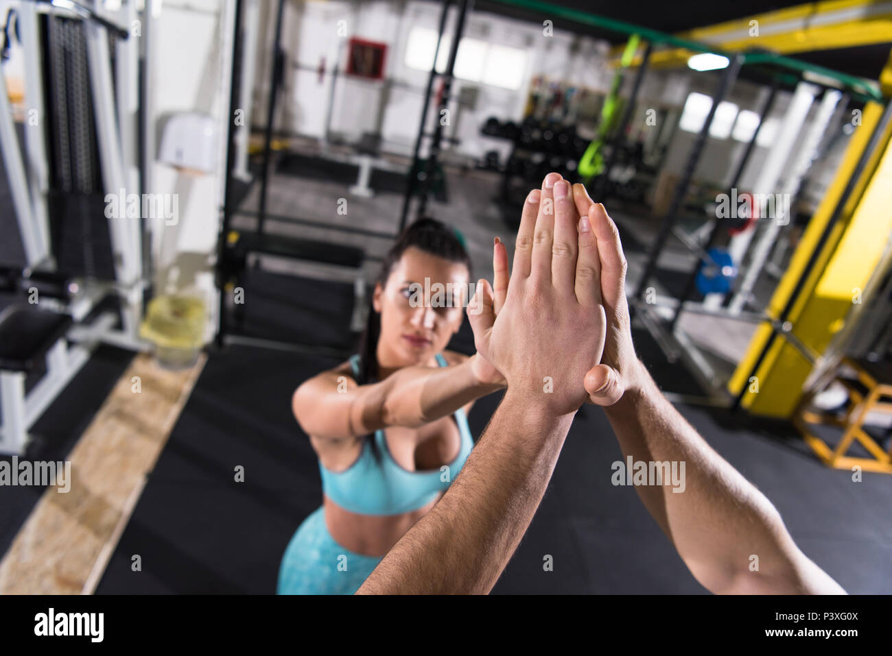 group of young athletes making high five after hard exercise at cross ...