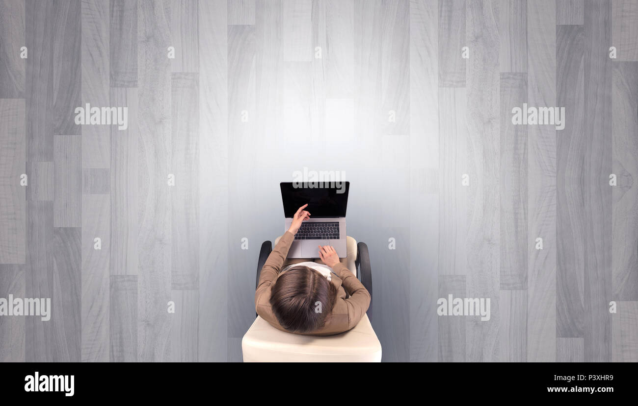 Empty office with woman in a chair and device on her hand Stock Photo ...