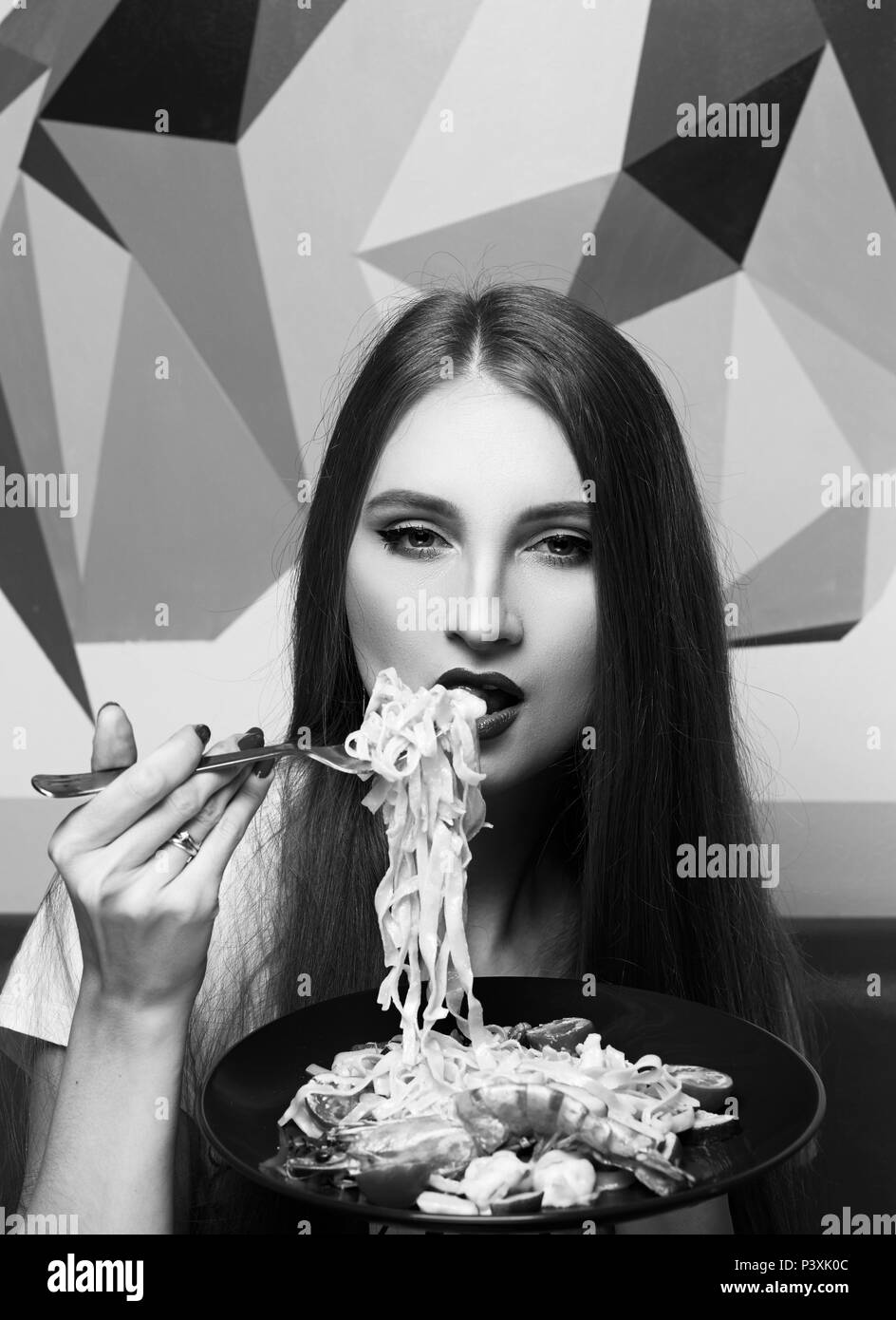 Girl eating spaghetti Black and White Stock Photos & Images - Alamy