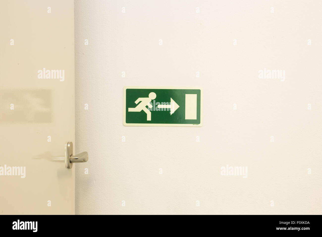 The emergency exit sign shows the direction of escape in case of danger ...