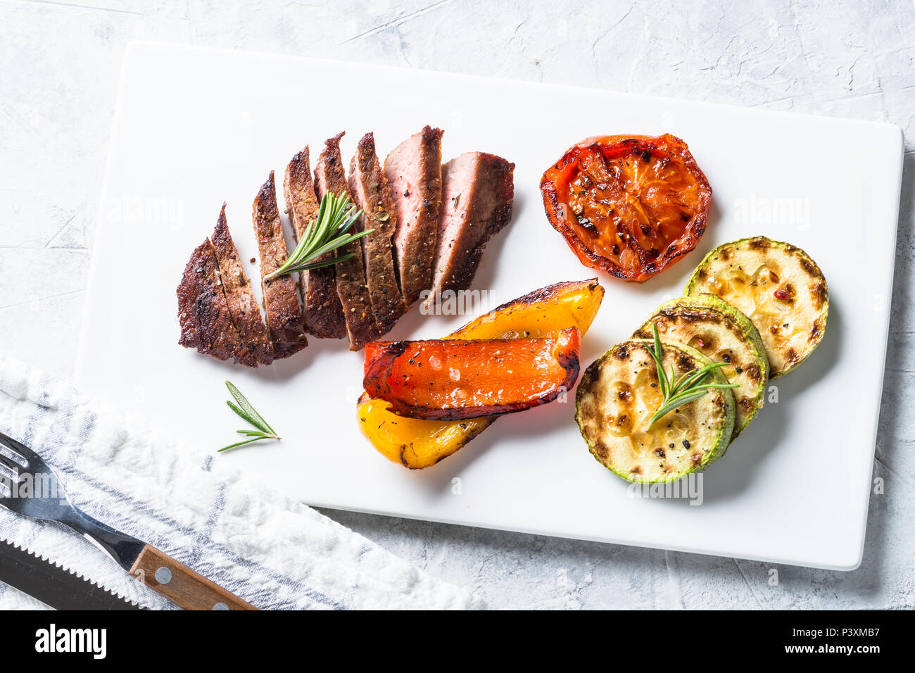 Beef steak and grilled vegetables. Restaurant serving dishes. Top view ...