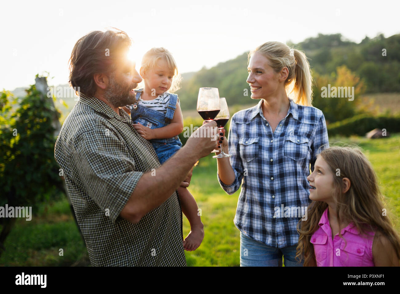 Winemaker family together in vineyard Stock Photo - Alamy