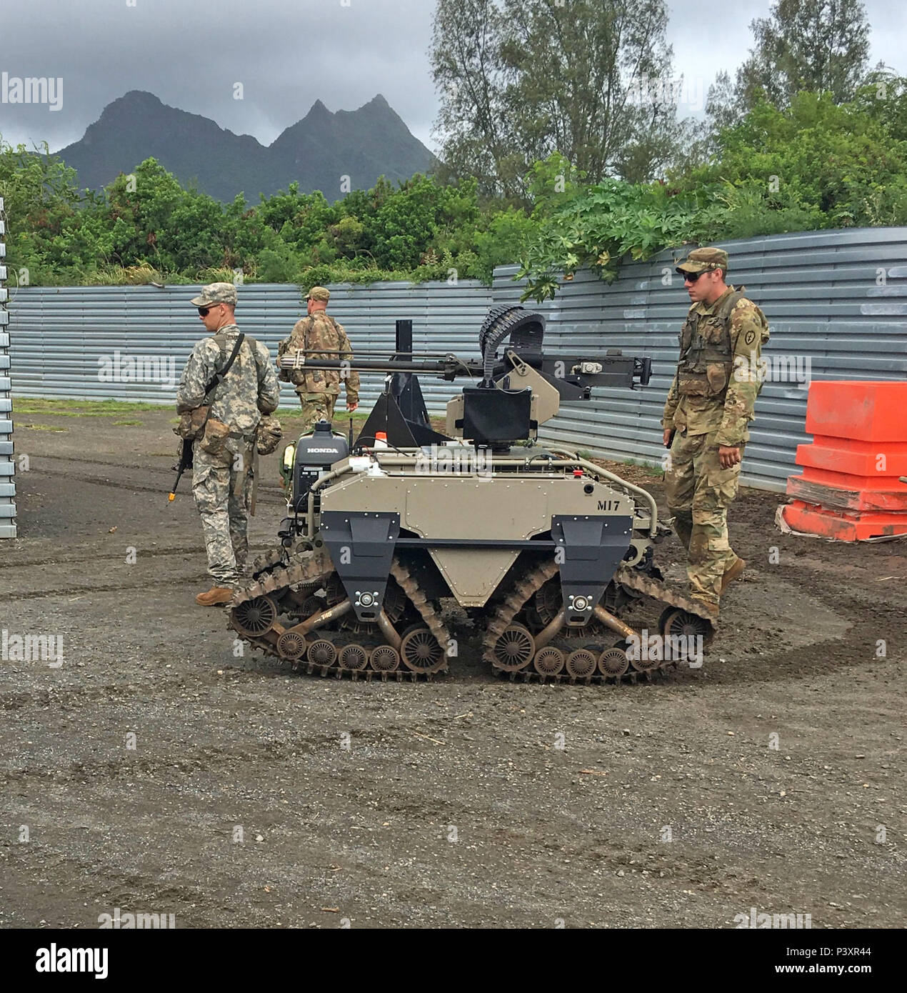 Soldiers of the 25th Infantry Division stand near a multipurpose ...