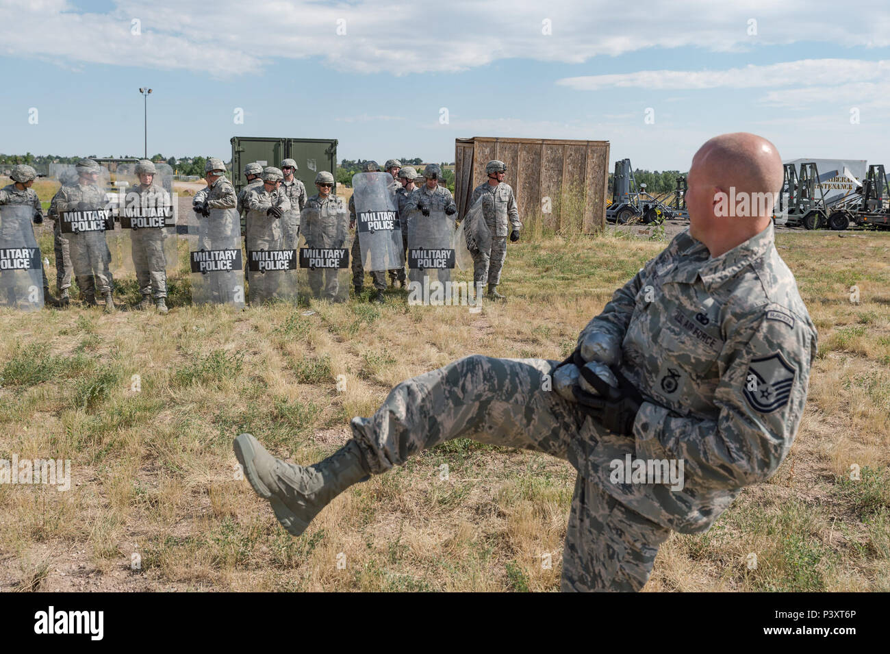 U.S. Air Force Master Sgt. Gregory Wardle hurls foam balls at defenders ...