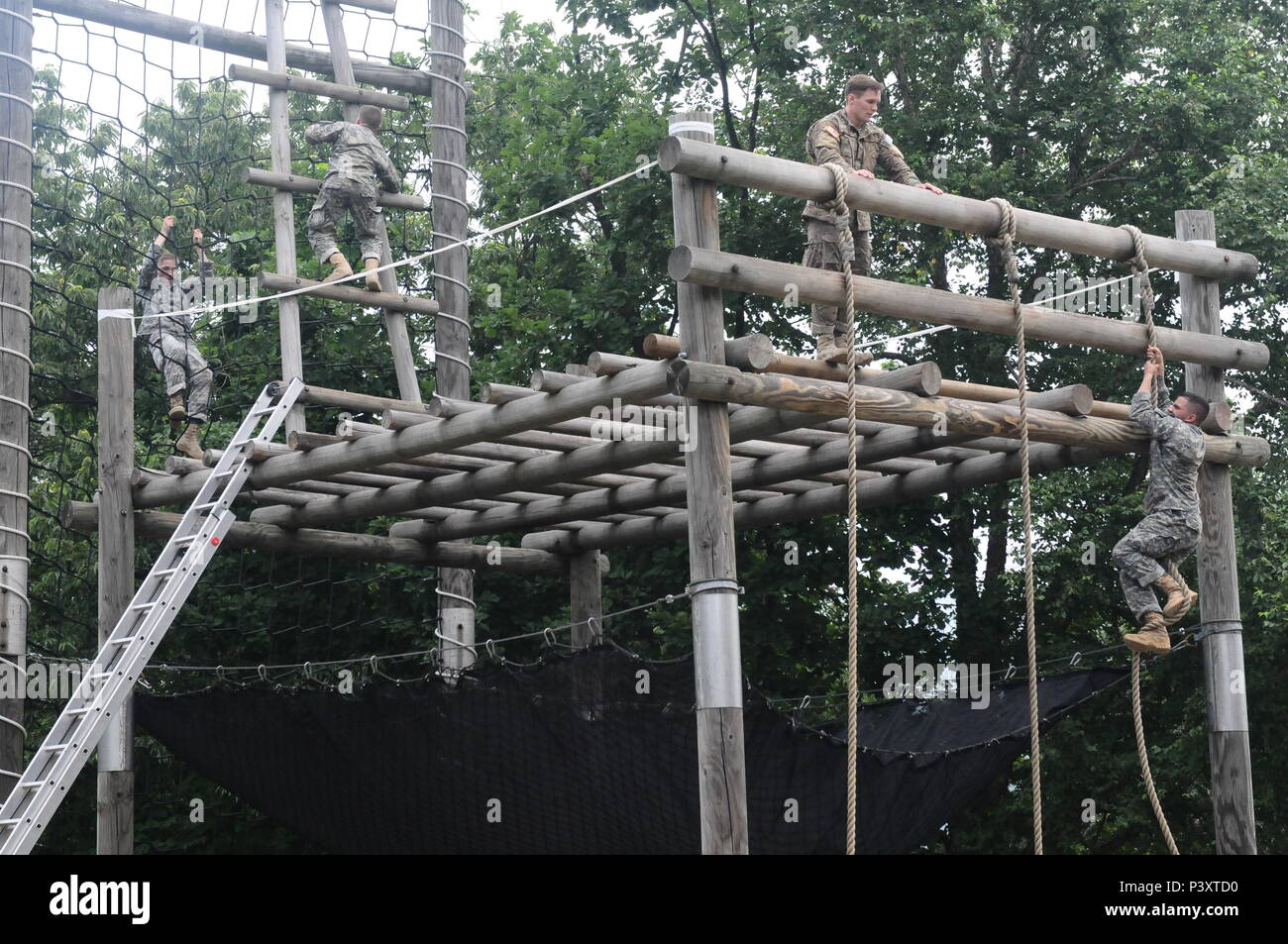 Soldiers attending the Air Assault course engage in an obstacle during ...