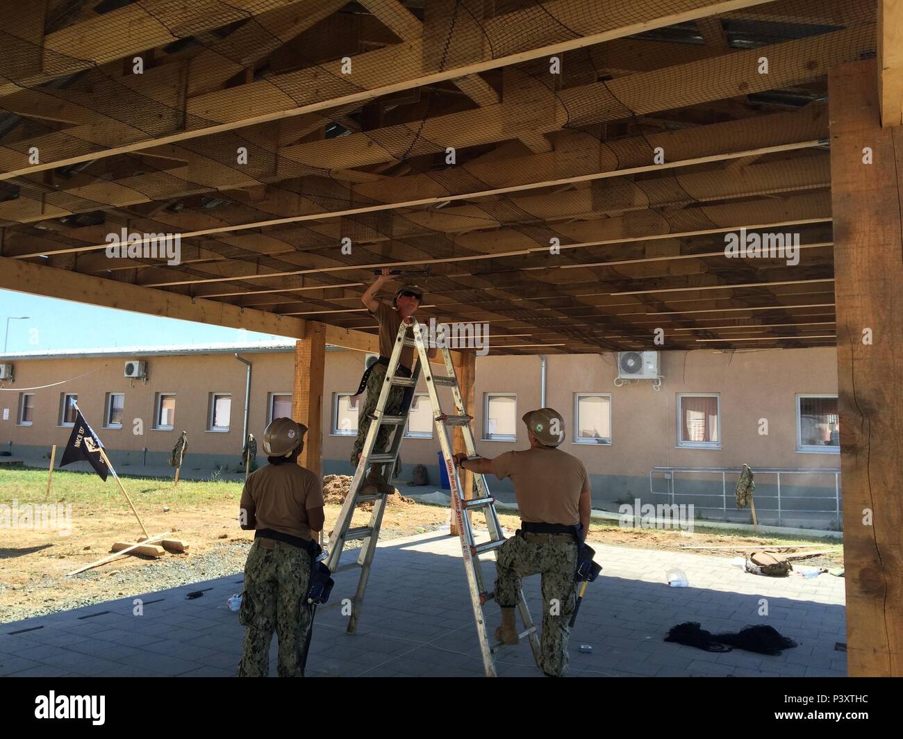 Sailors from the Naval Mobile Construction Battalion 133 finish a ...