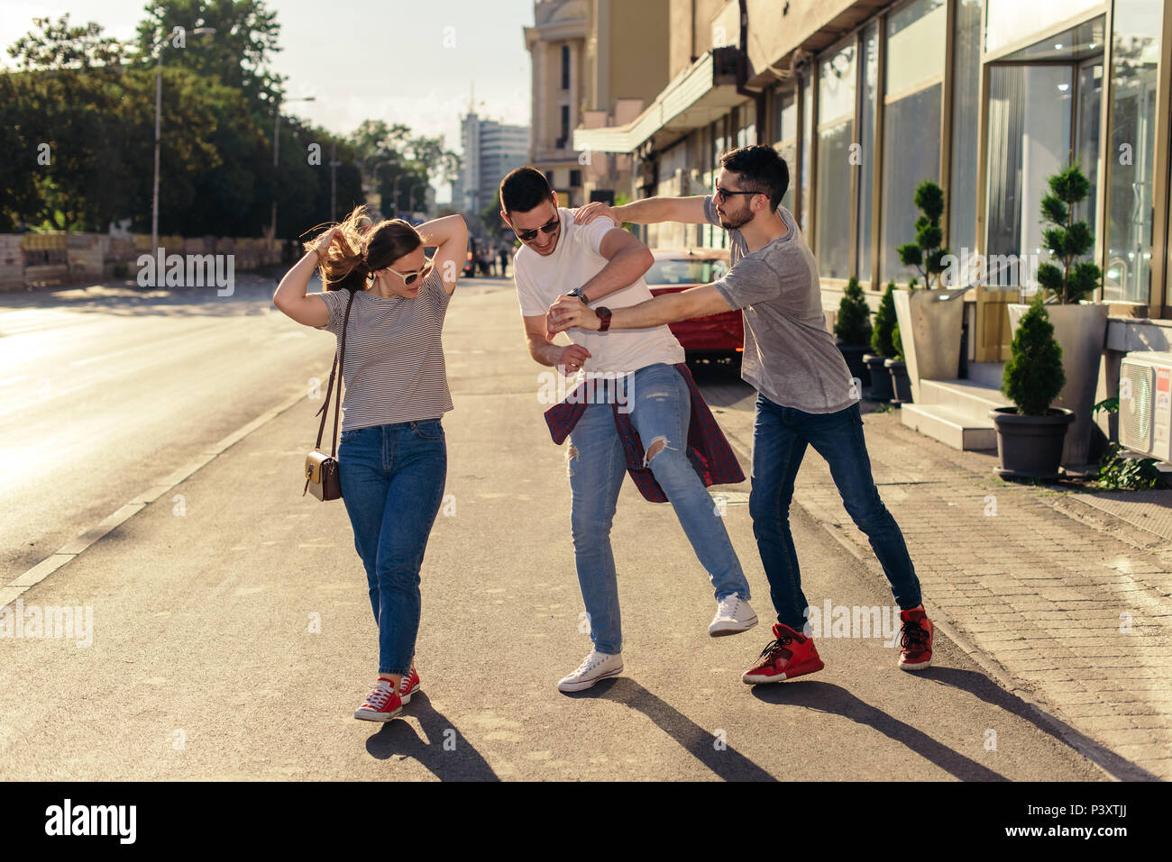 Happy group of young people walking together on sunny day Stock Photo ...