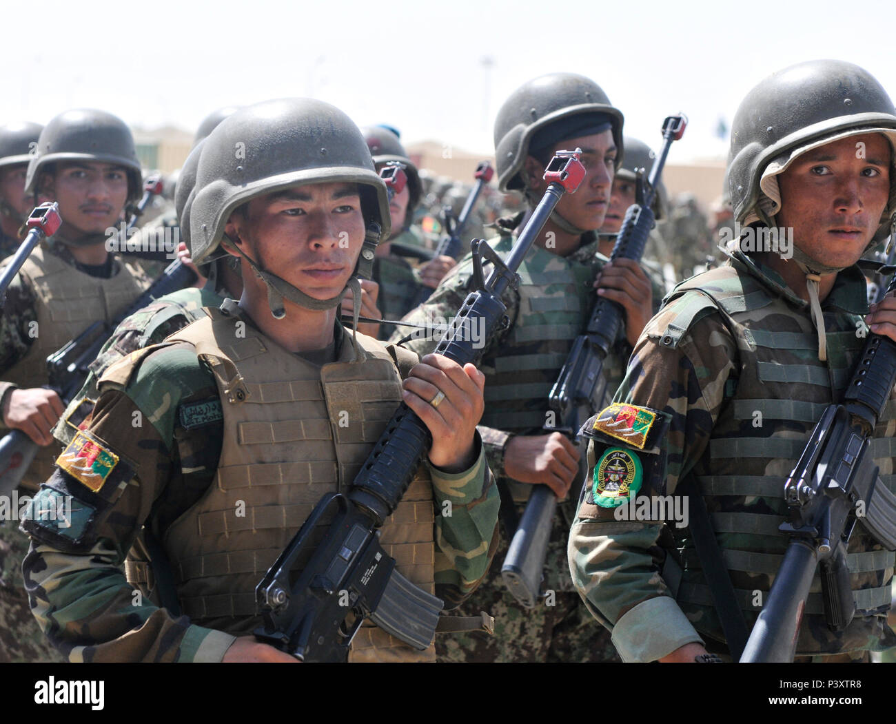 Young Afghan Soldiers march forward after graduating with their fellow ...