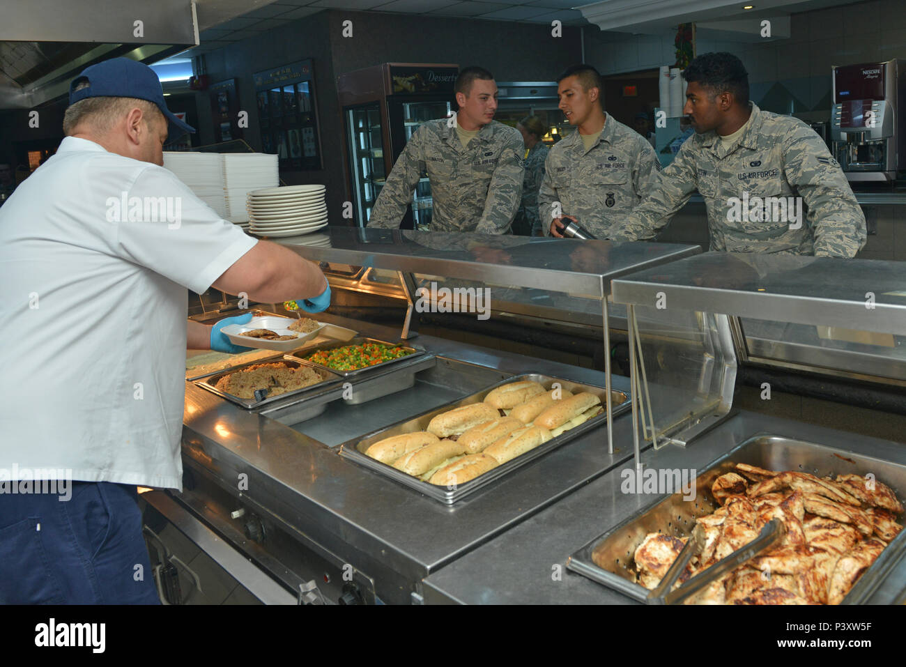 A U.S. Air Force services employee serves food for Airmen in the Sultan ...