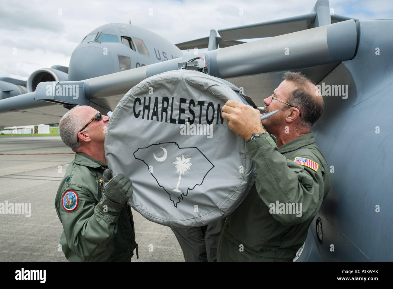 Lt. Col. Craig Bartosh, 701st Airlift Squadron pilot, helps Chief ...