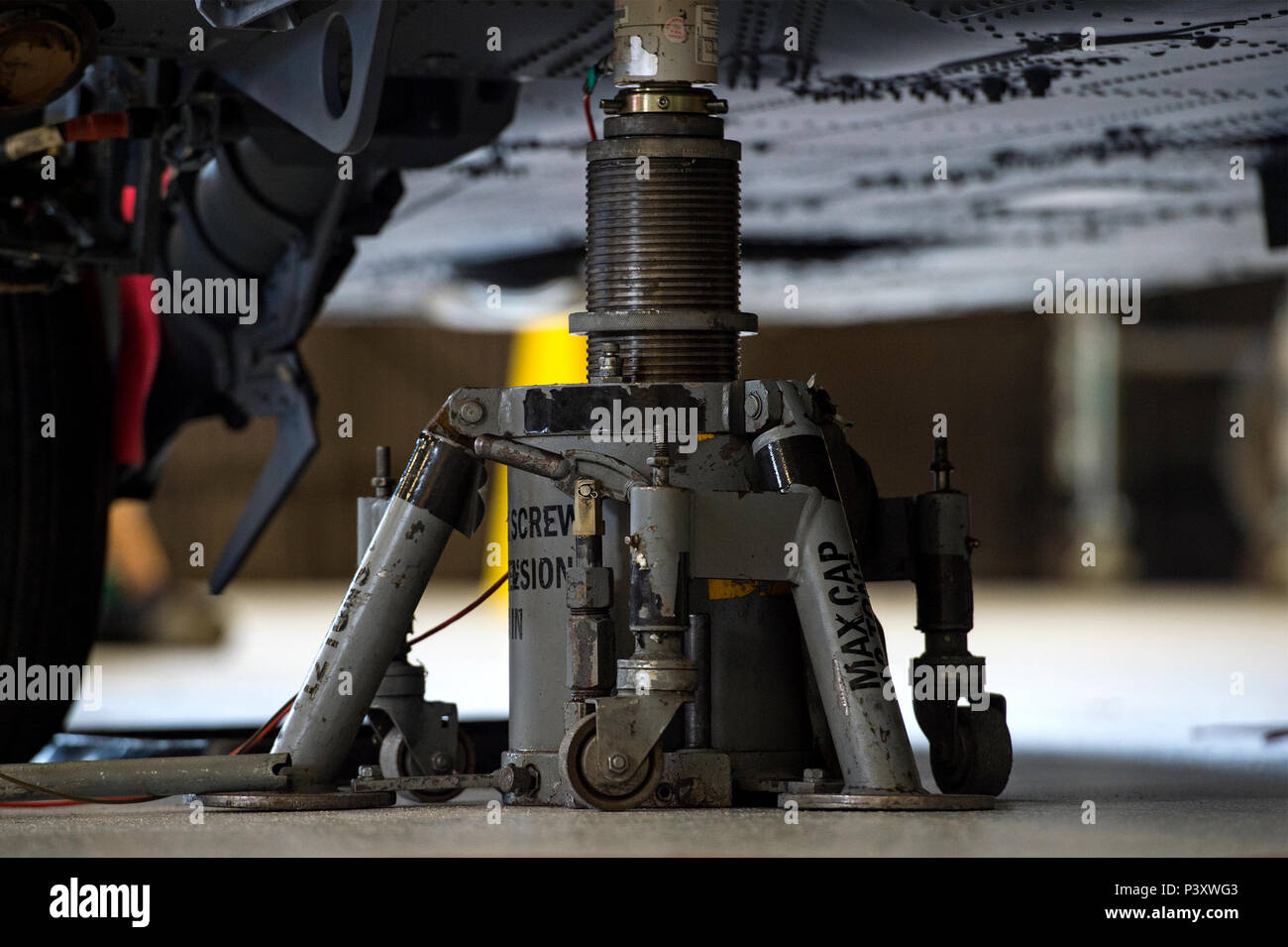 A helicopter jack stand sits under an HH-60G Pave Hawk helicopter, July ...