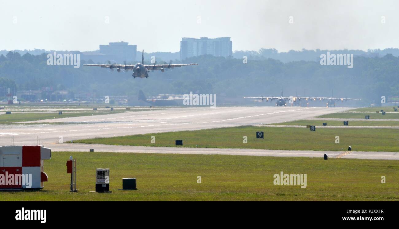 A formation of C-130 Hercules from the 700th Airlift Squadron take off ...