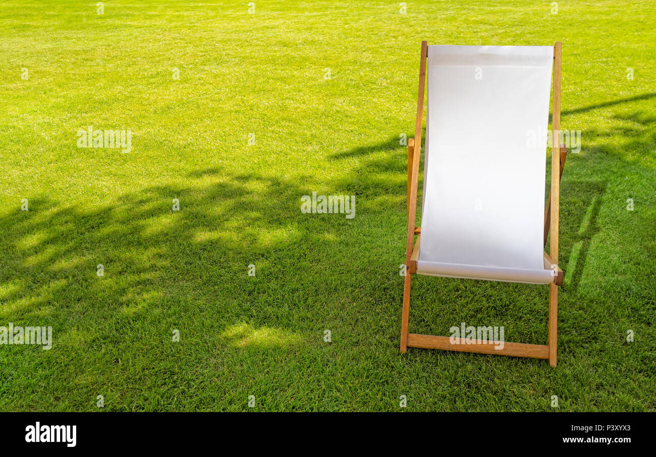 Single White Empty Deck Chair on Lawn Stock Photo - Alamy