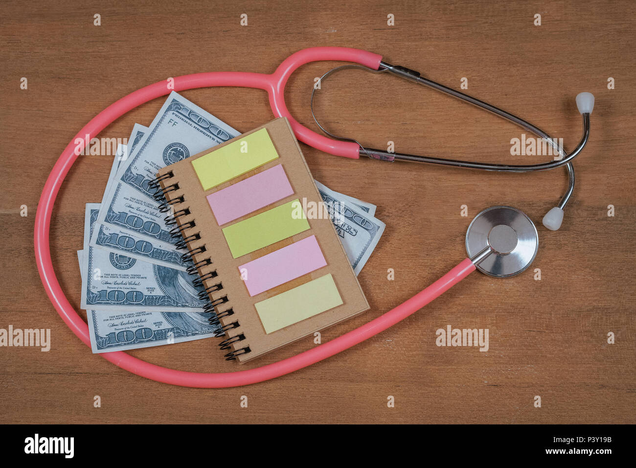 Pink stethoscope with paper note on wood background Stock Photo - Alamy