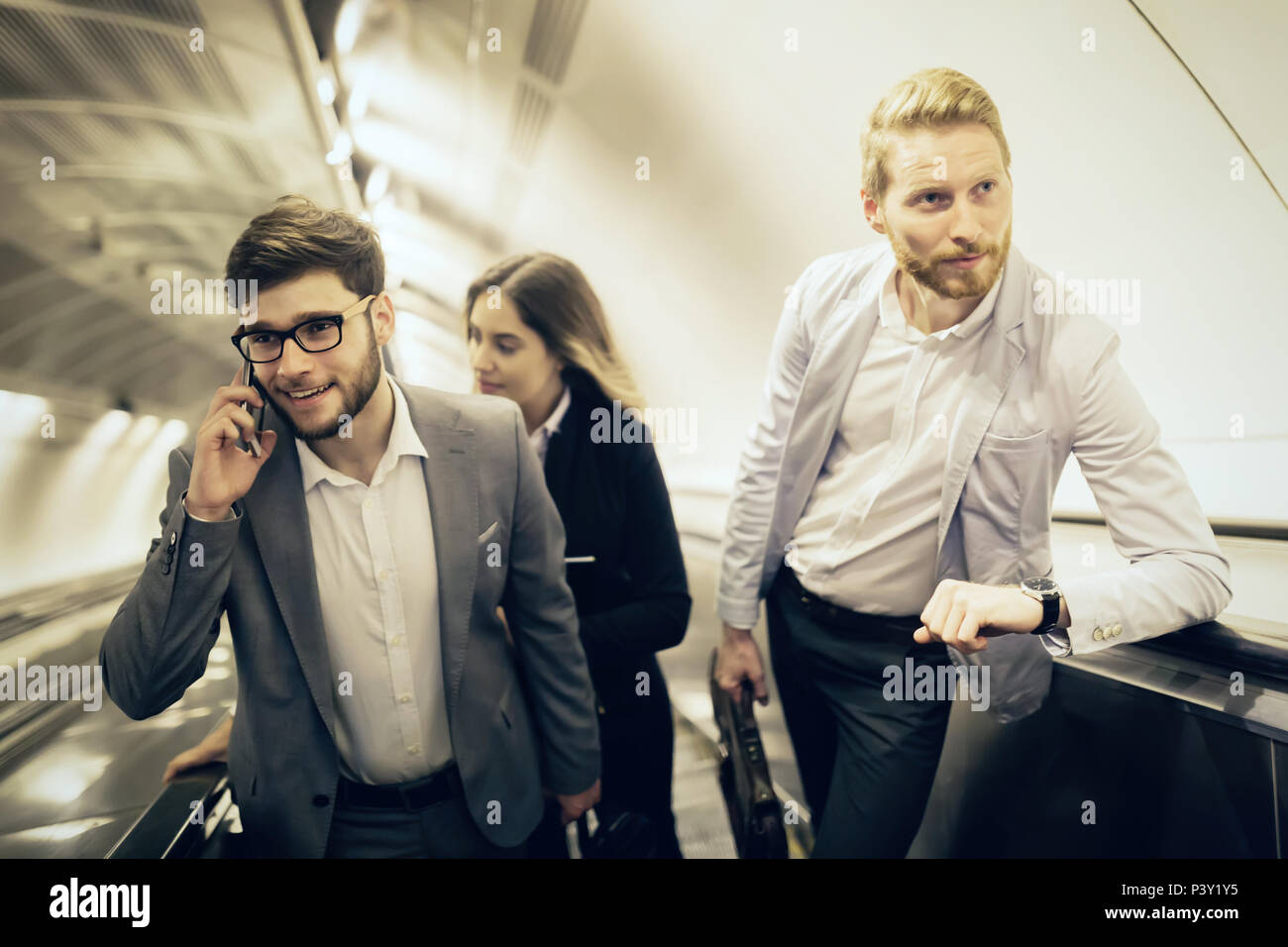 Business colleagues taking subway after work Stock Photo - Alamy