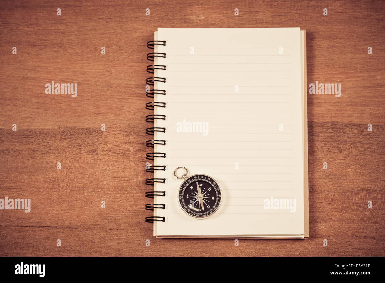 vintage compass on book note and fountain pen on wood table Stock Photo ...