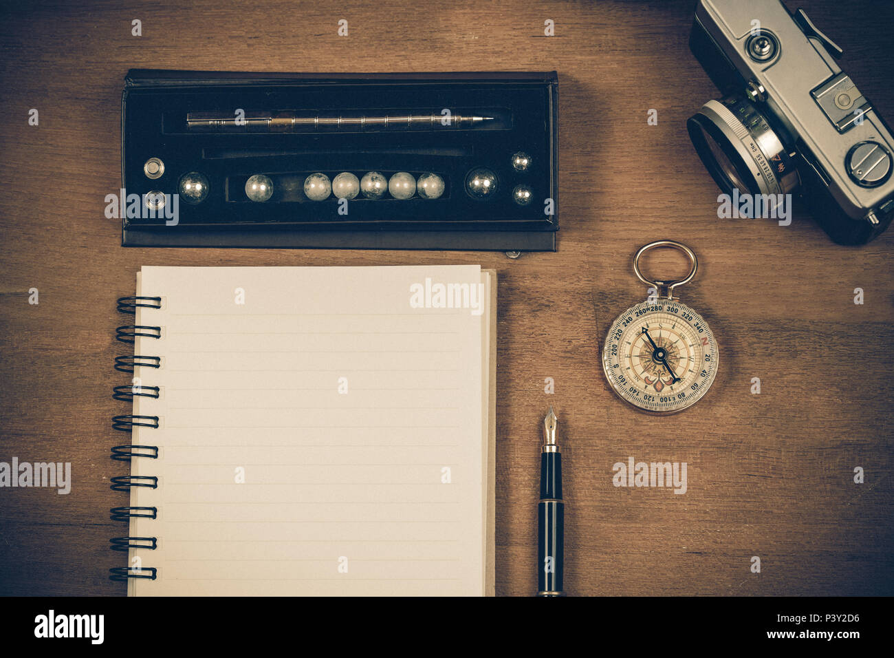 vintage compass on book note and fountain pen on wood table Stock Photo ...