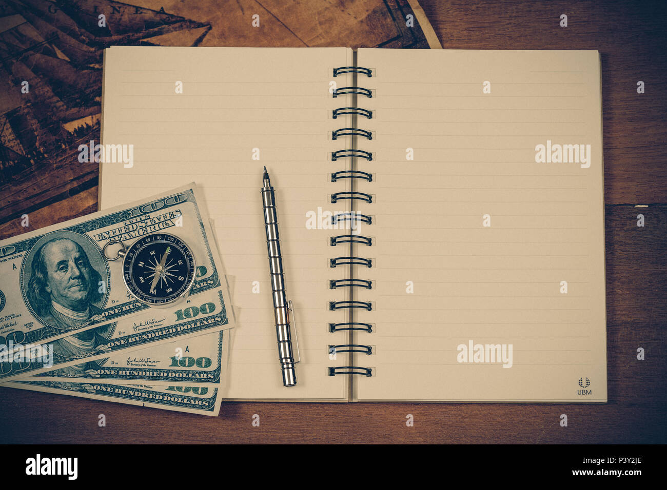 vintage compass on book note and fountain pen on wood table Stock Photo ...