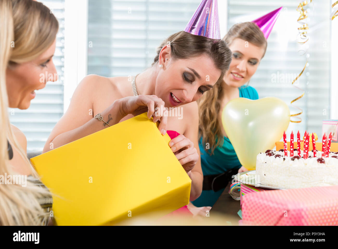 Beautiful woman opening a gift box while celebrating her birthday Stock ...