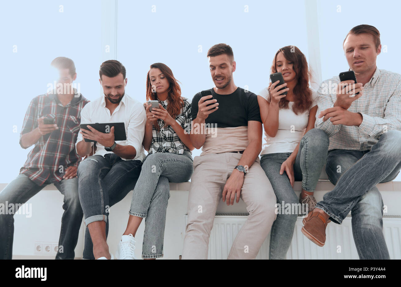 young people in casual clothes using gadgets Stock Photo - Alamy