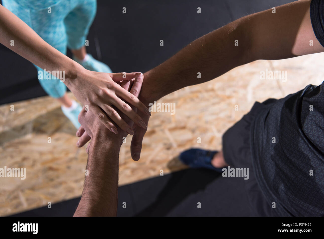 group of young athletes making high five after hard exercise at cross ...