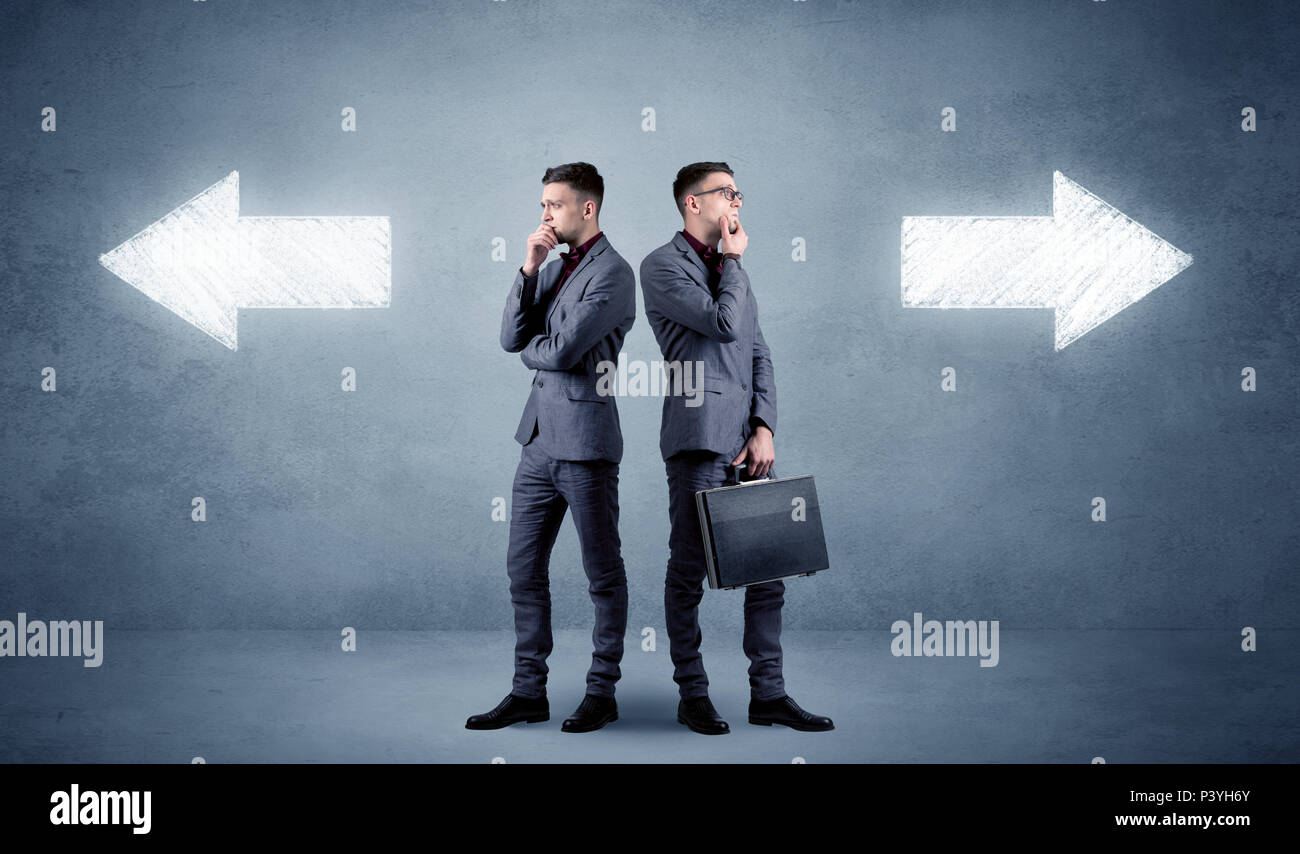 Young conflicted businessman choosing between two directions Stock ...