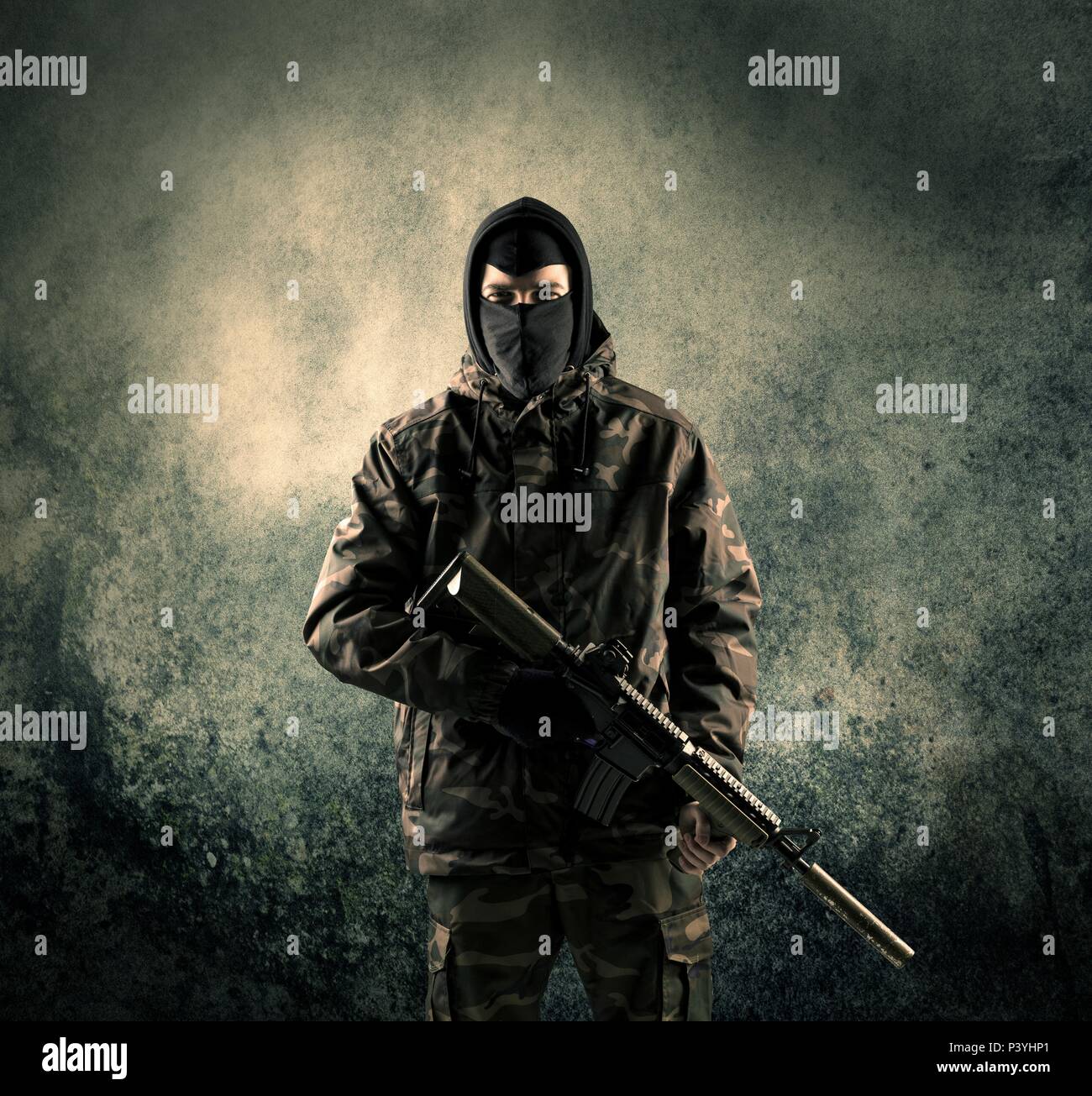 Portrait of a heavily armed masked soldier with grungy background ...