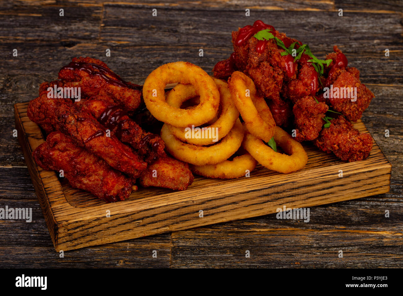 Chicken wings, leg and onion fry plate Stock Photo - Alamy