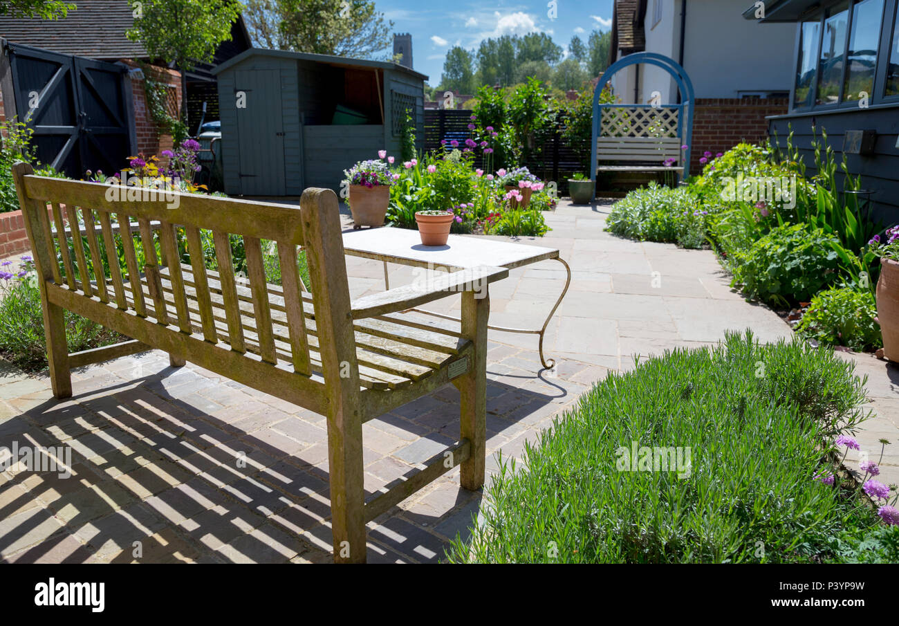 Overview of garden patio featuring two separate seating areas and a log ...