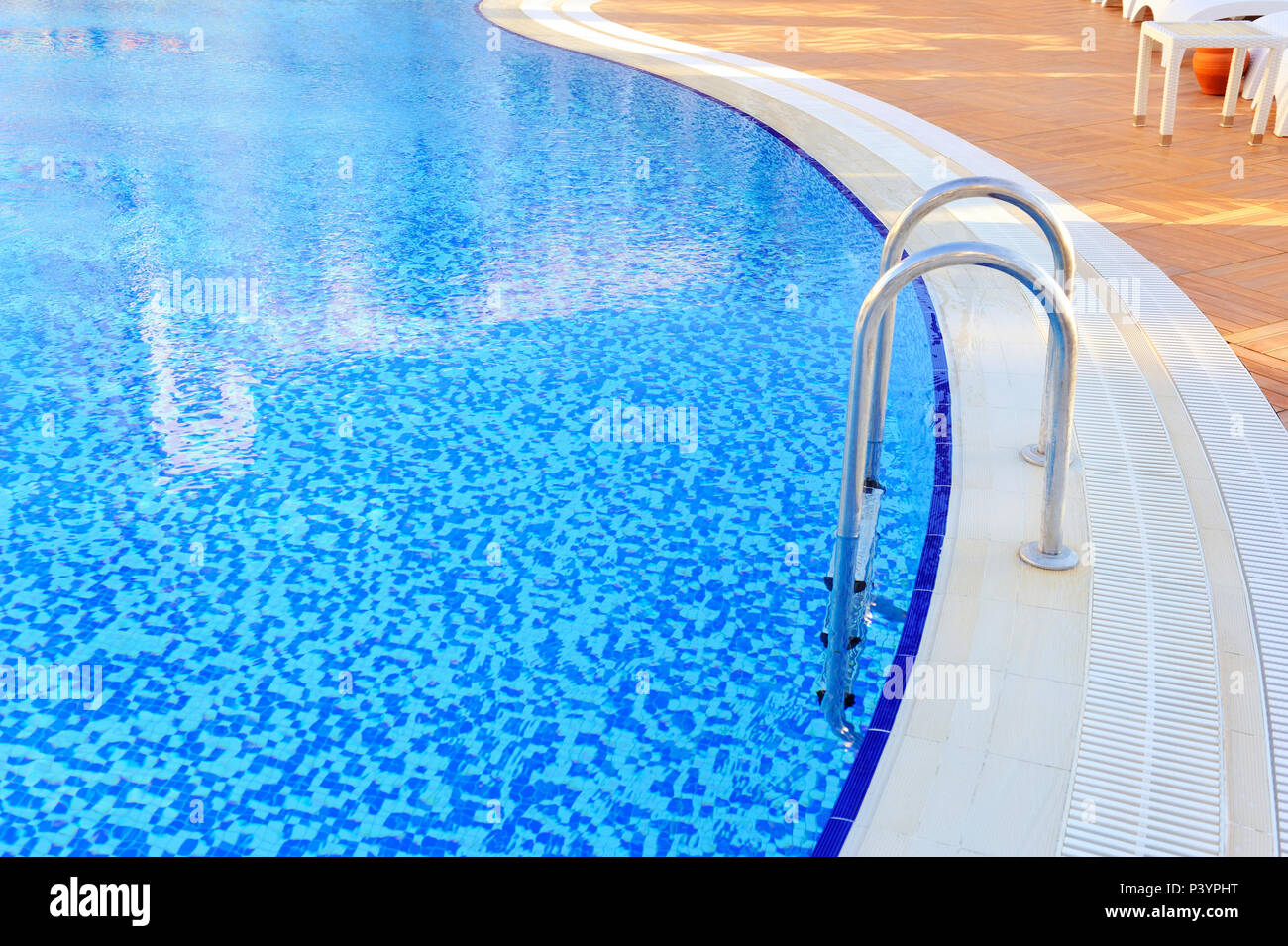 Swimming pool with stair at hotel close-up Stock Photo - Alamy