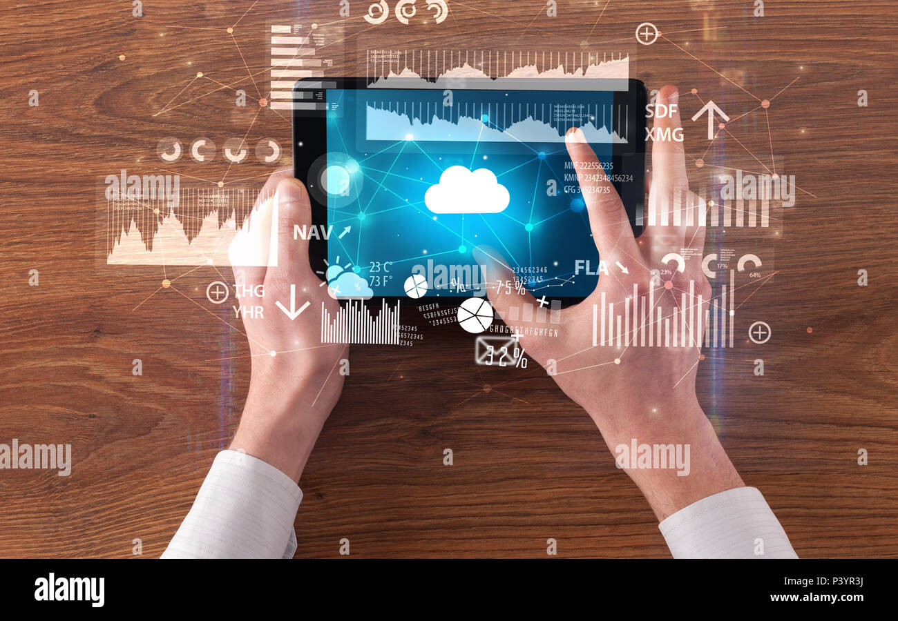 Hand holding tablet and checking finantial report on cloud computing ...