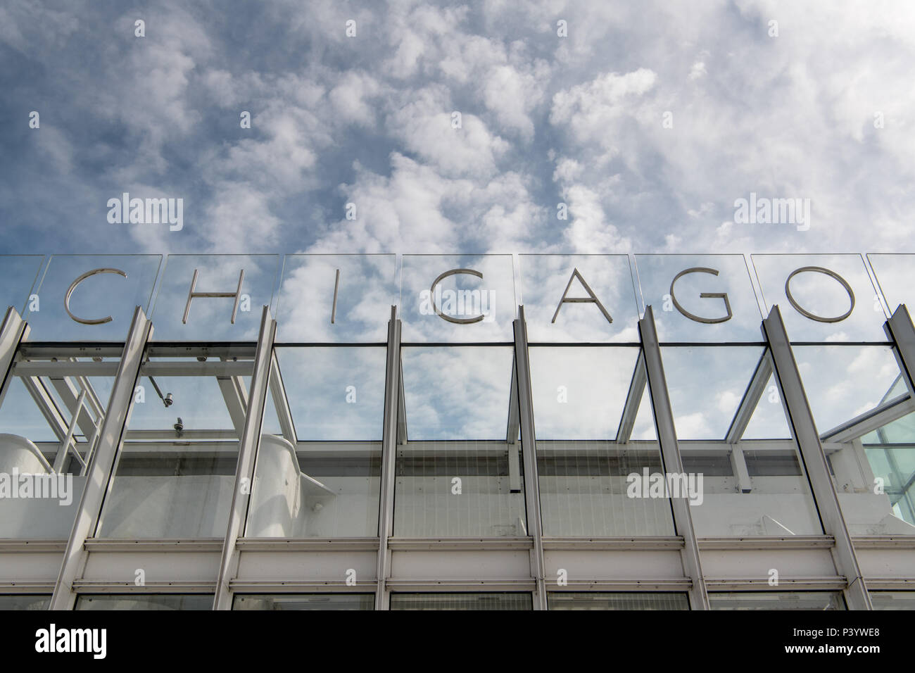 Modern glass and steel Chicago sign against backdrop of blue sky and ...