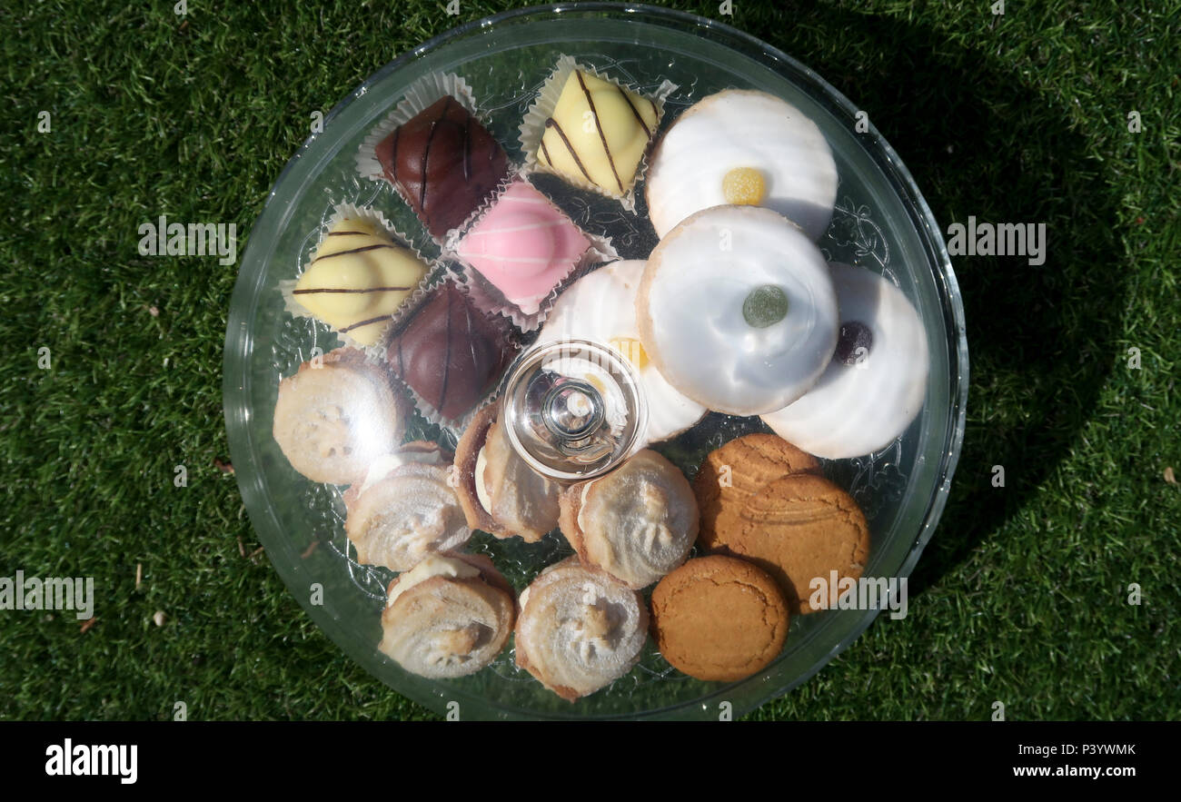 Selection of cakes under glass dome Stock Photo - Alamy