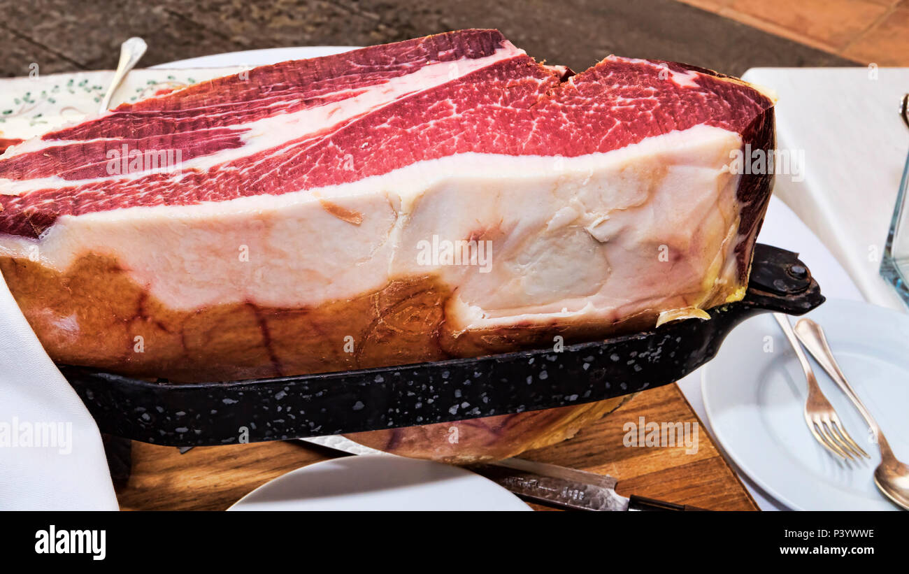 Italian ham leg ready to be sliced - selective focus Stock Photo - Alamy