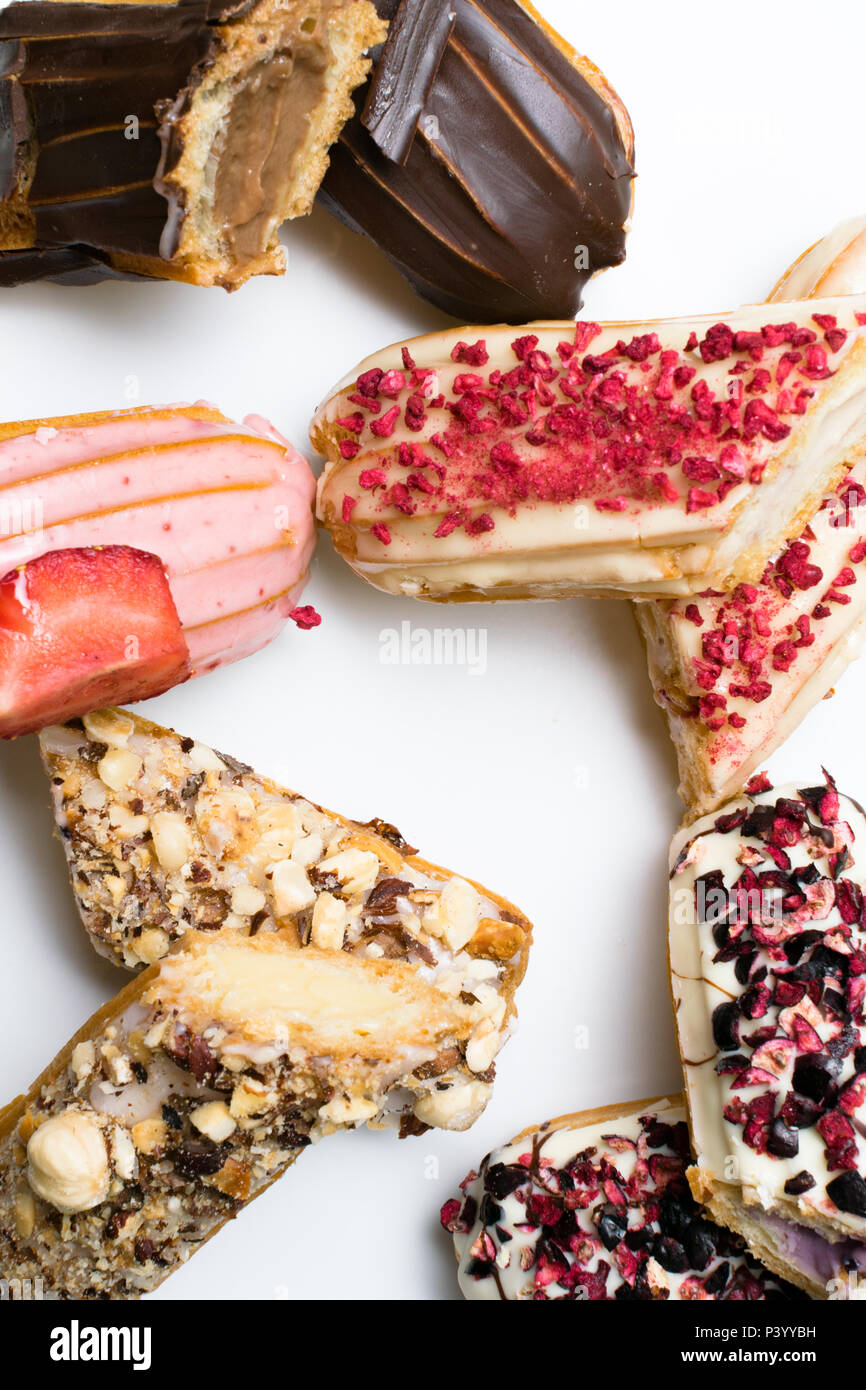 Sweet and colorful french eclairs with berrys, chocolate, nuts. Group ...