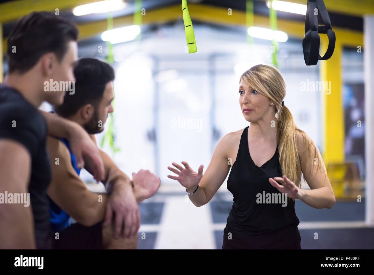 group of young healthy athletic people training jumping on fit box at ...