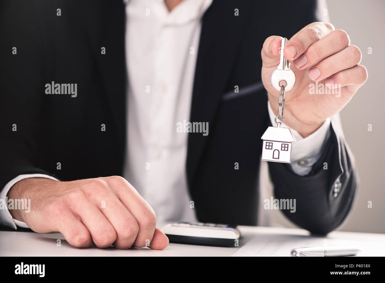 Real estate agent handing an house key. New home concept Stock Photo ...