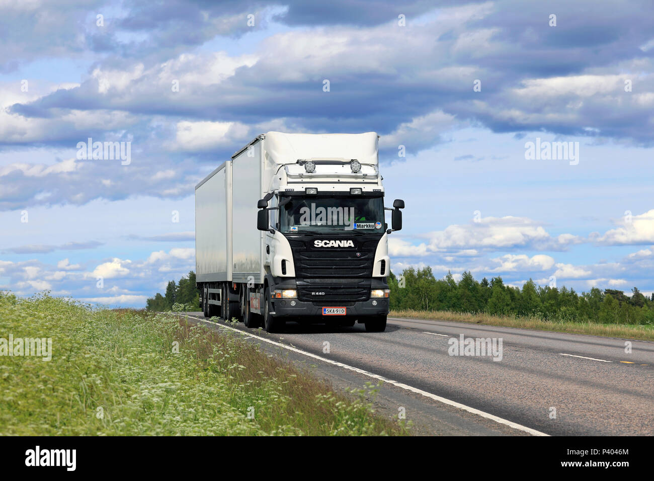 White Scania R440 truck and full trailer of Melkoset Oy hauls goods ...