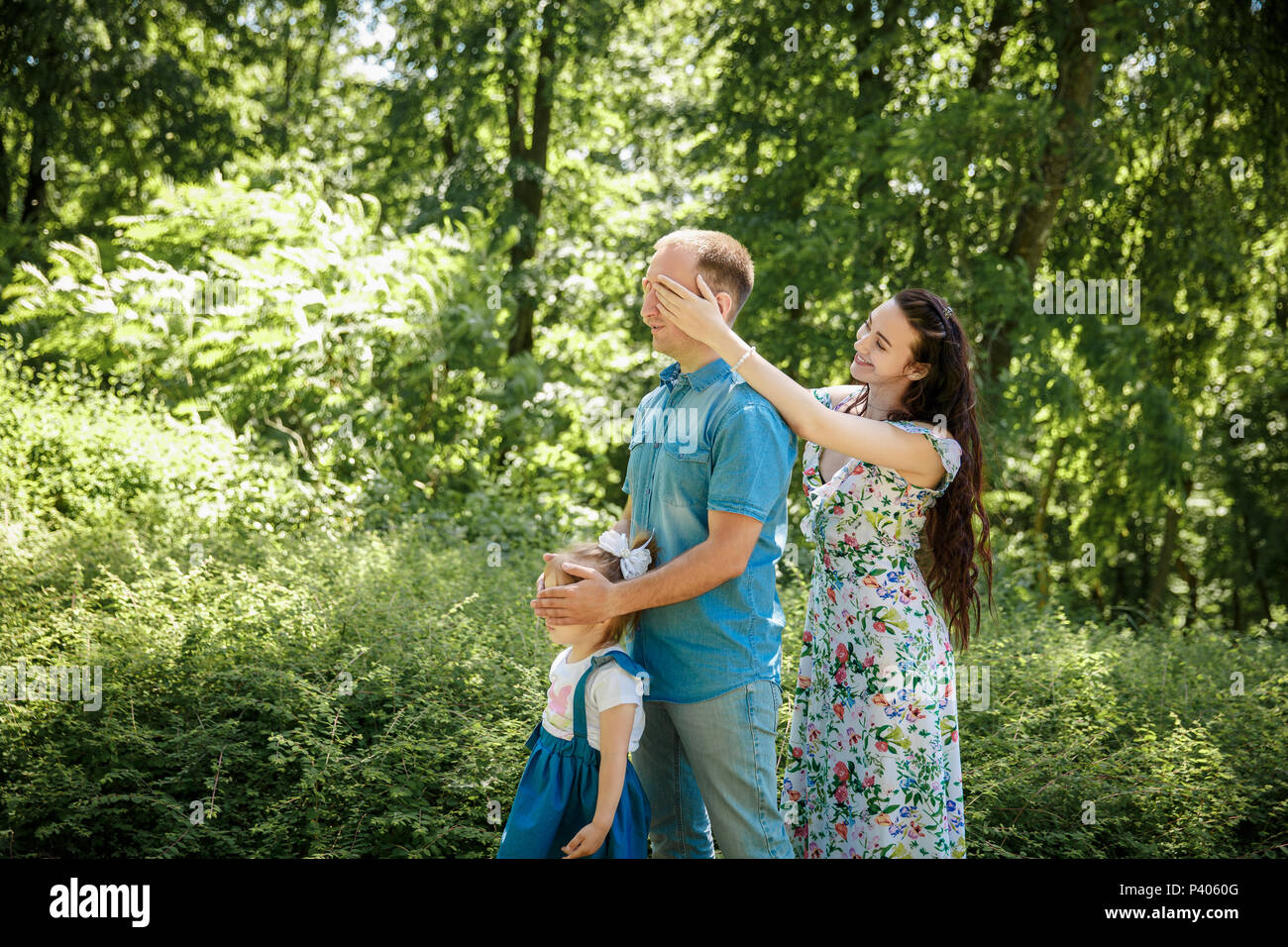 Guess who. family closes each other's eyes Stock Photo - Alamy Guess who. family closes each other's eyes Stock Photo - Alamy