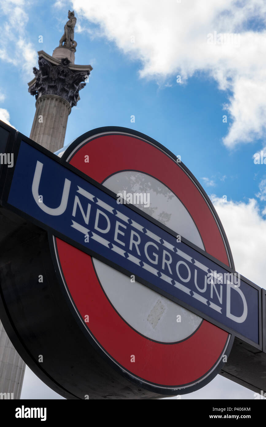 the london tube or underground transport for london sign next to nelson ...