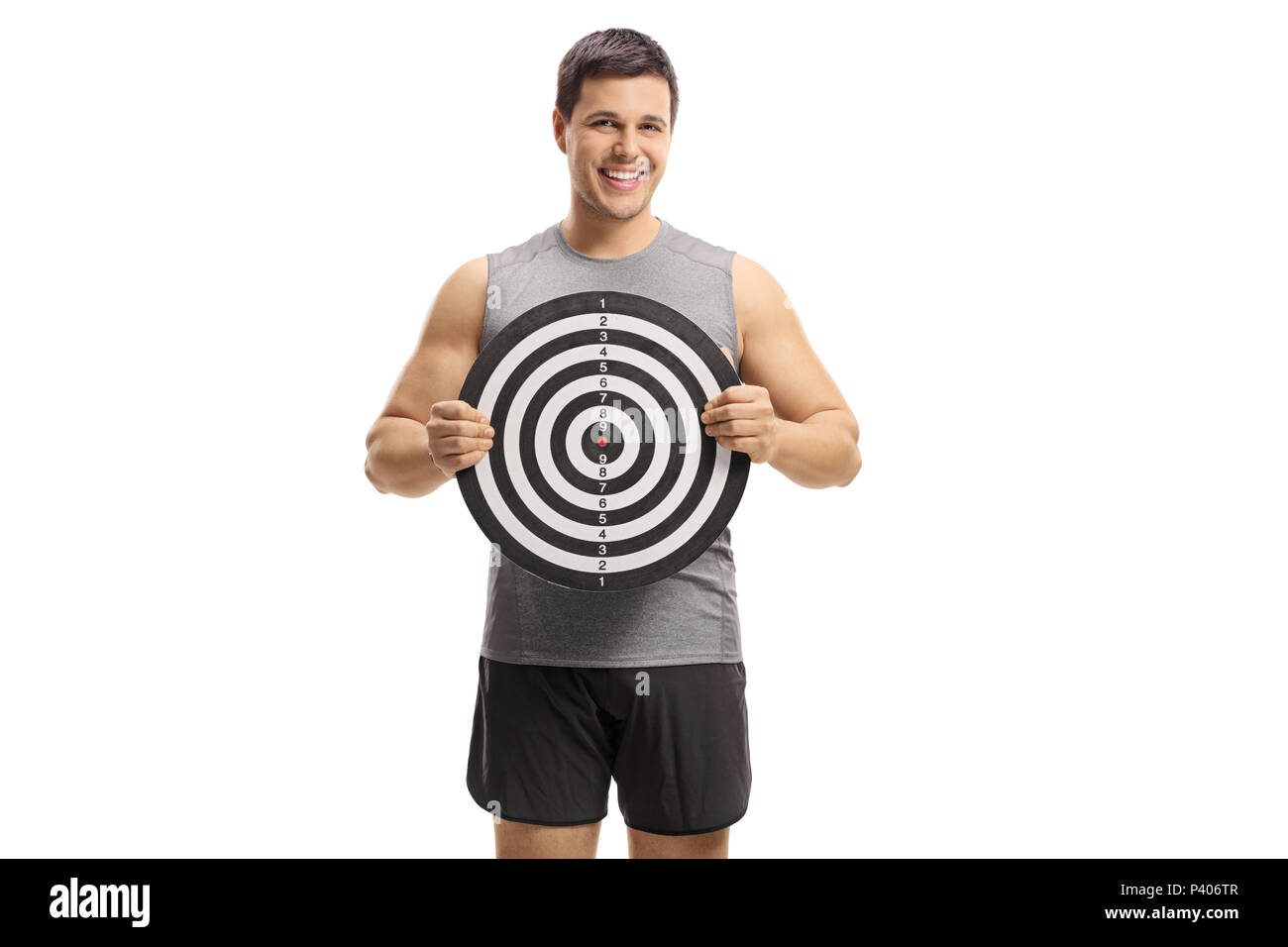 Young man in sportswear holding a target isolated on white background ...