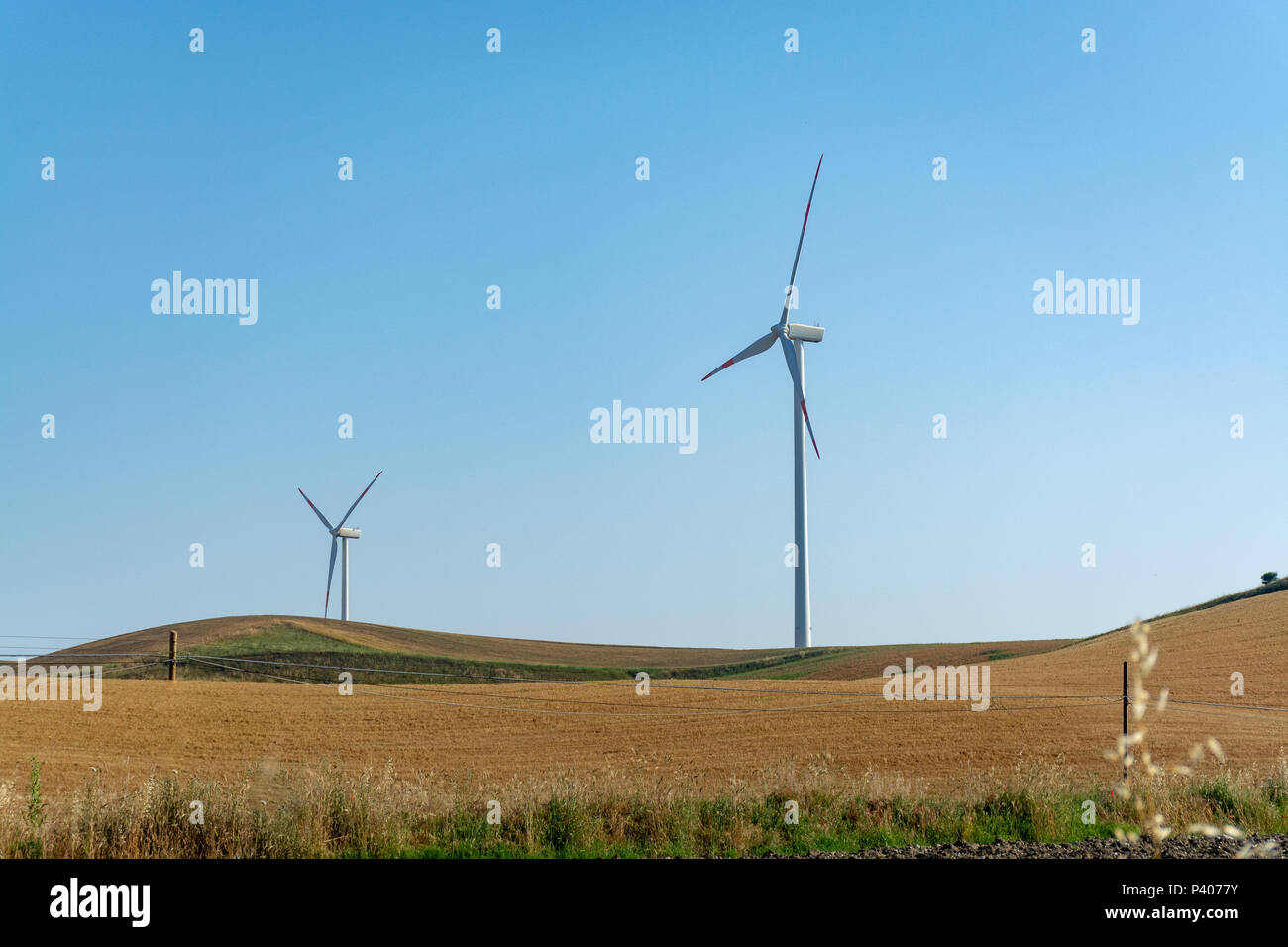 Modern wind farm with big wind turbines towers, source for renewable ...