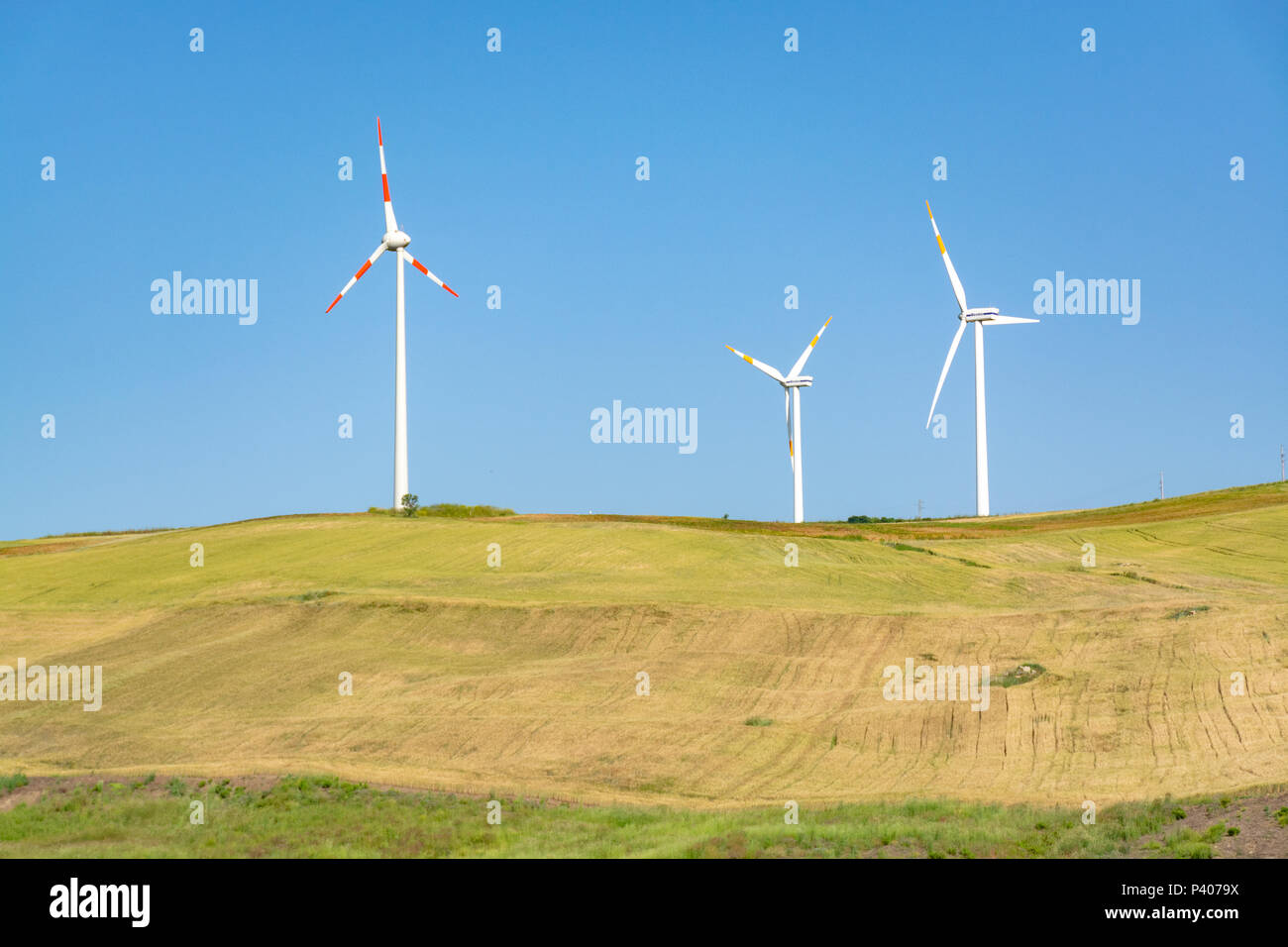 Modern wind farm with big wind turbines towers, source for renewable ...