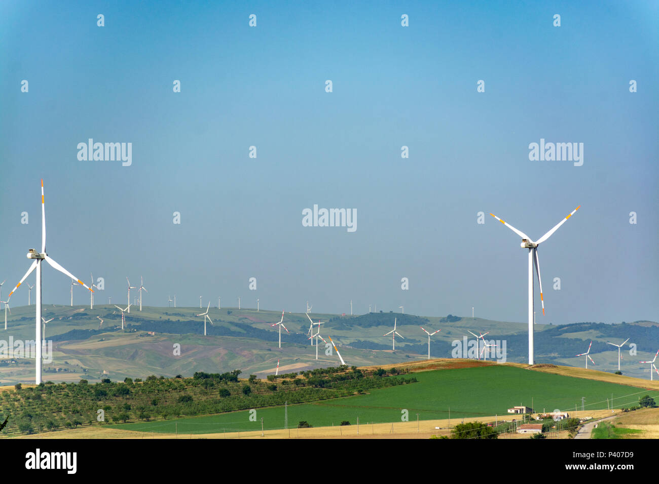 Modern wind farm with big wind turbines towers, source for renewable ...