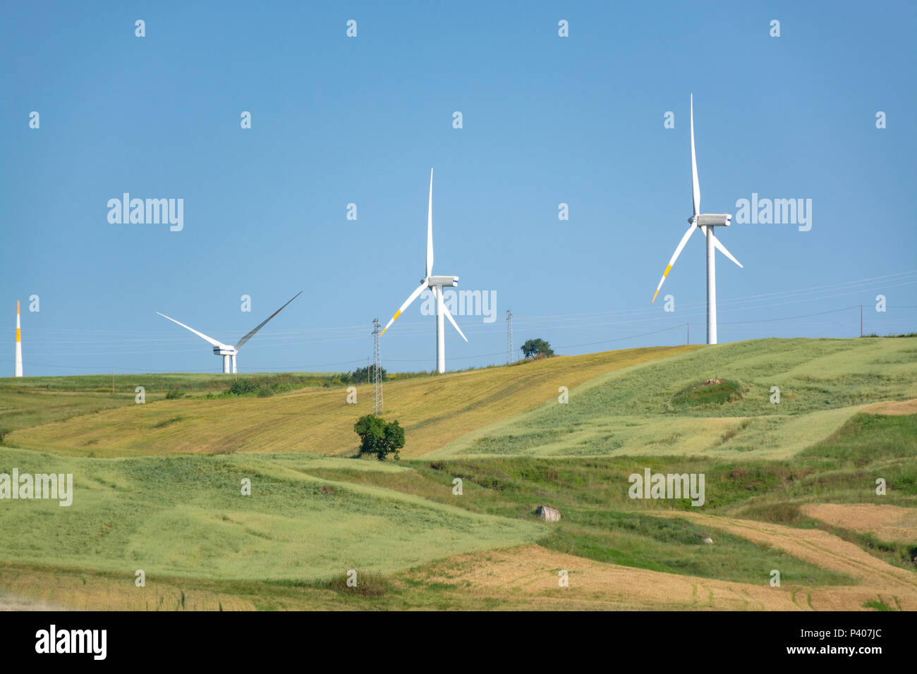 Modern wind farm with big wind turbines towers, source for renewable ...