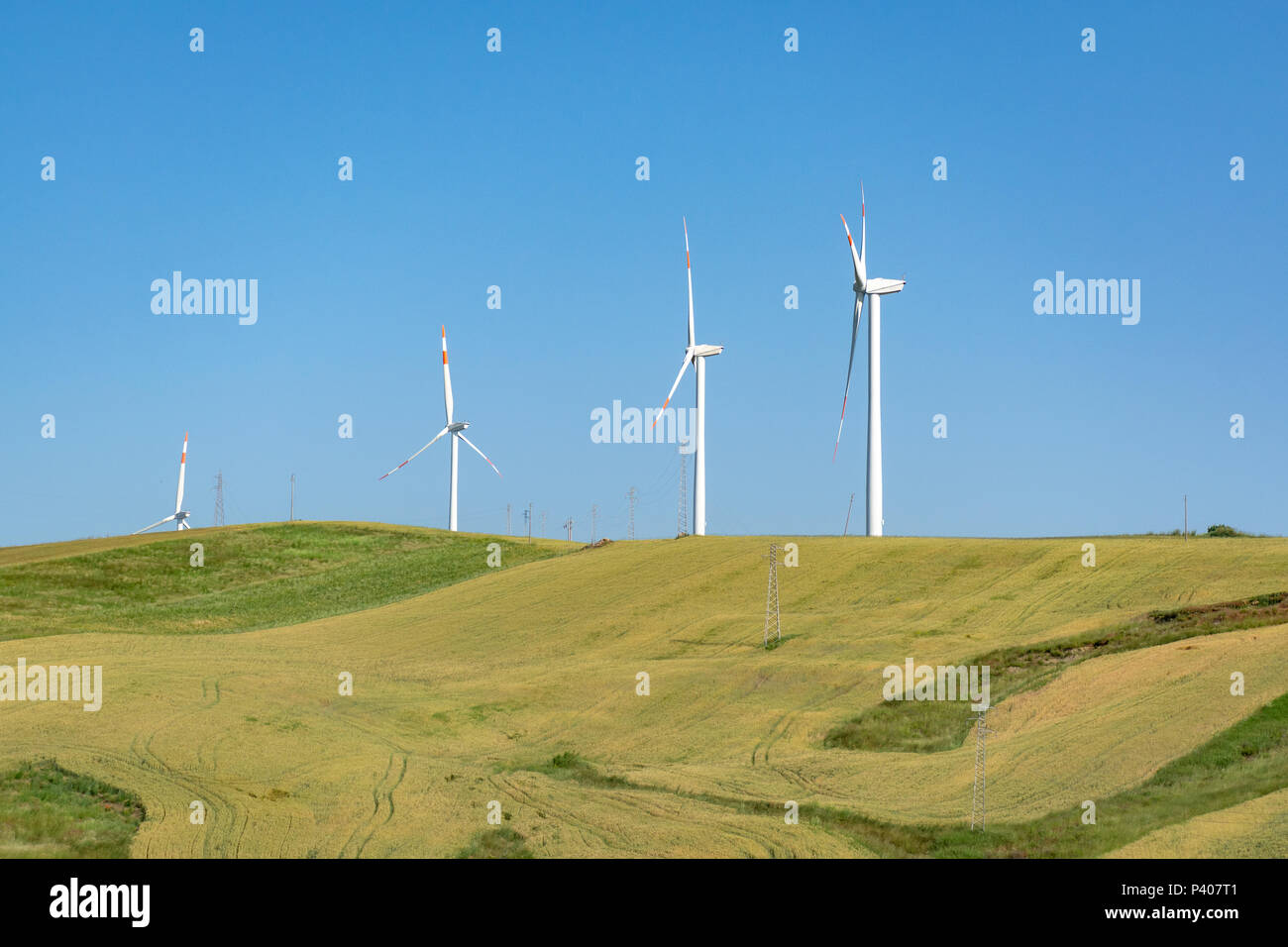 Modern wind farm with big wind turbines towers, source for renewable ...