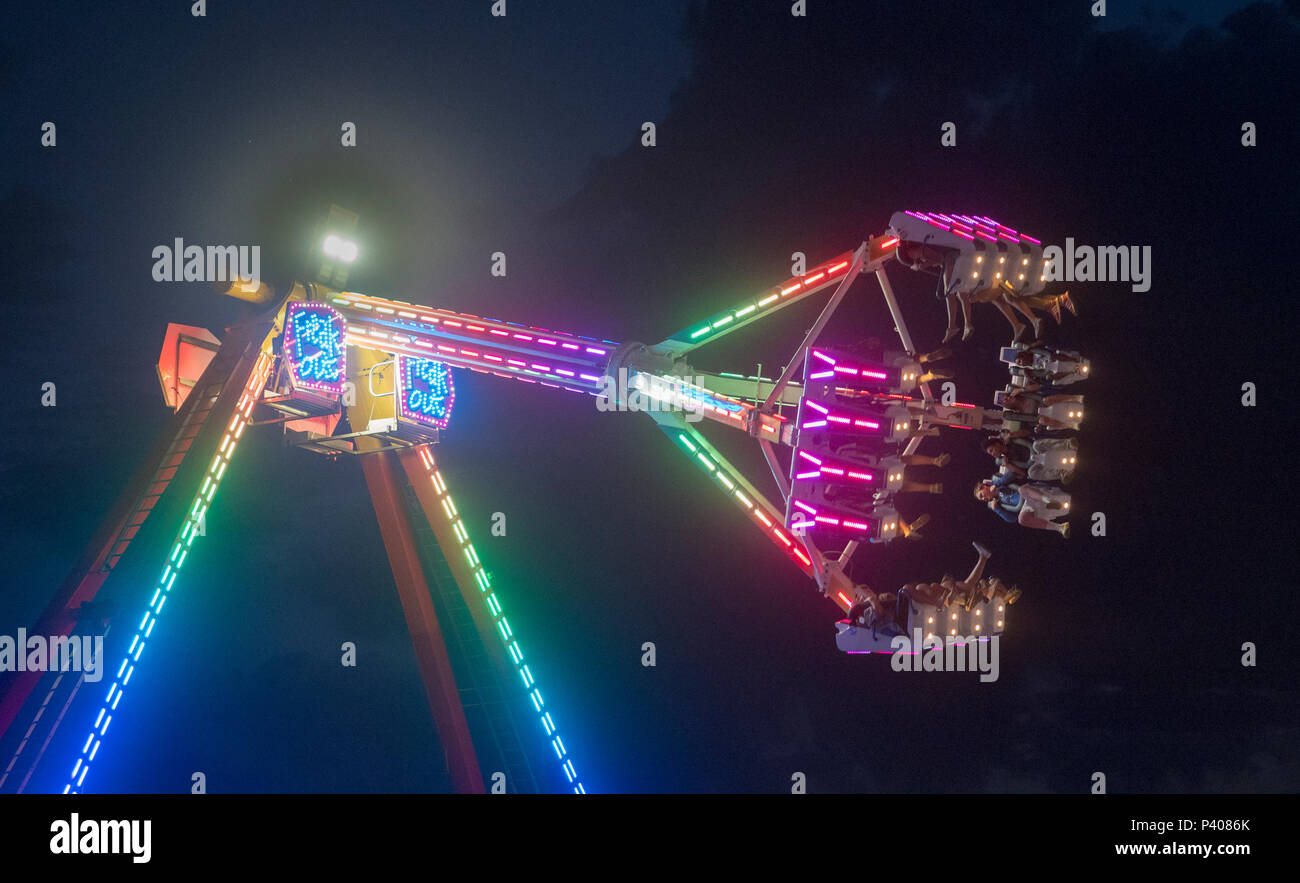 Heart-stopping carnival ride on a summer's evening Stock Photo - Alamy