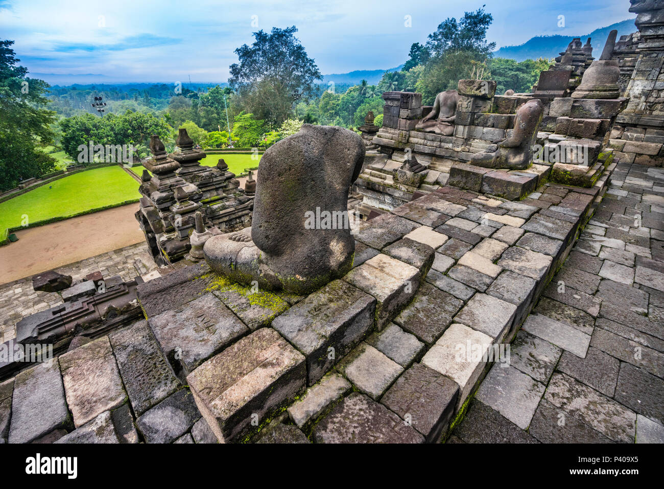 headless Buddha statues at a ballustrade of the 9th century Borobudur ...